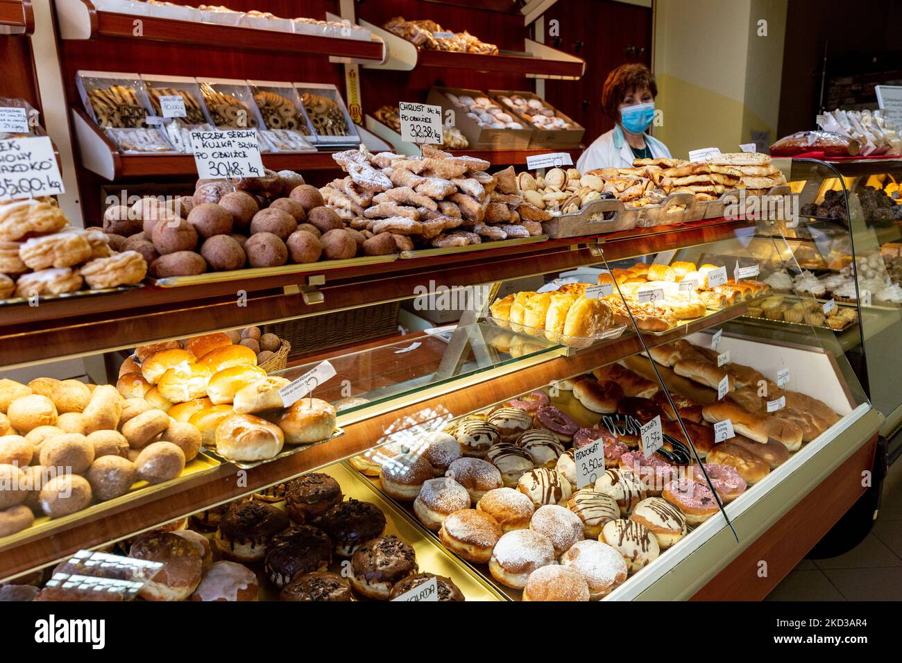 A wonam sals donuts in a bakery on traditional Fat Thursday holiday in ...
