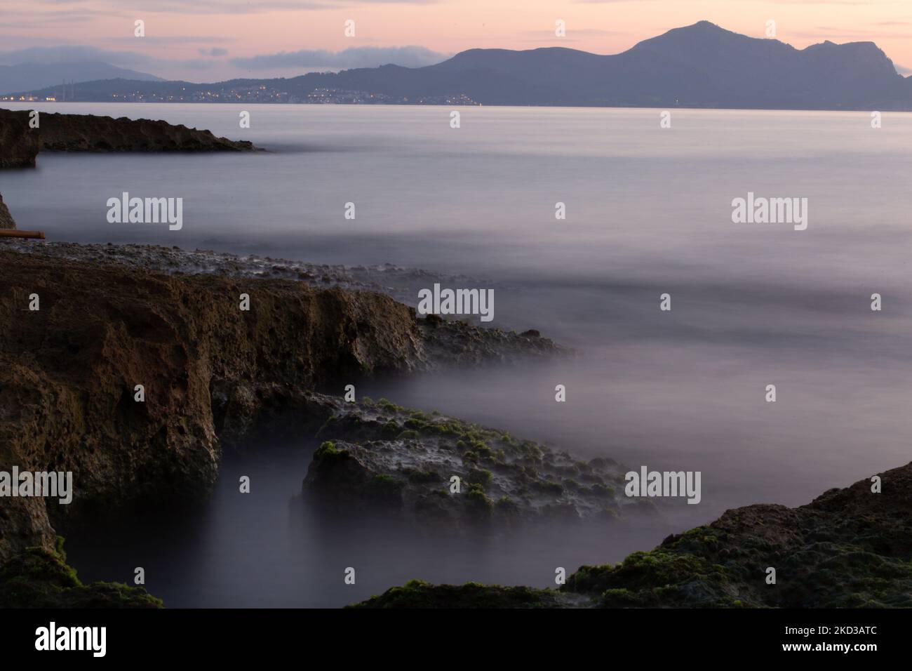 An aerial view of a floating layer of clouds over rocky mountains and cliffs Stock Photo - Alamy