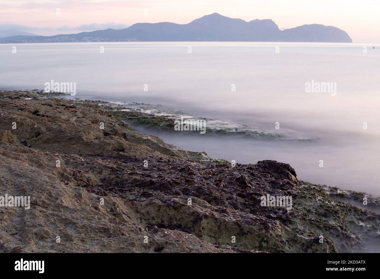 An aerial view of a floating layer of clouds over rocky mountains and cliffs Stock Photo - Alamy