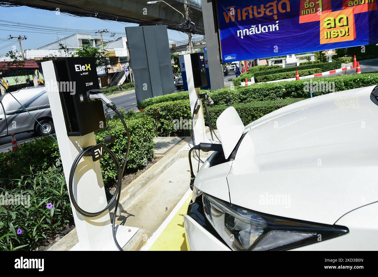 An electric vehicle (EV) is charged at an electric vehicle charging ...