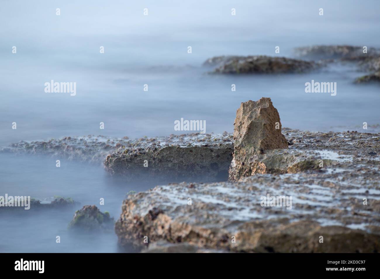 An aerial view of a floating layer of clouds over rocky mountains and cliffs Stock Photo - Alamy