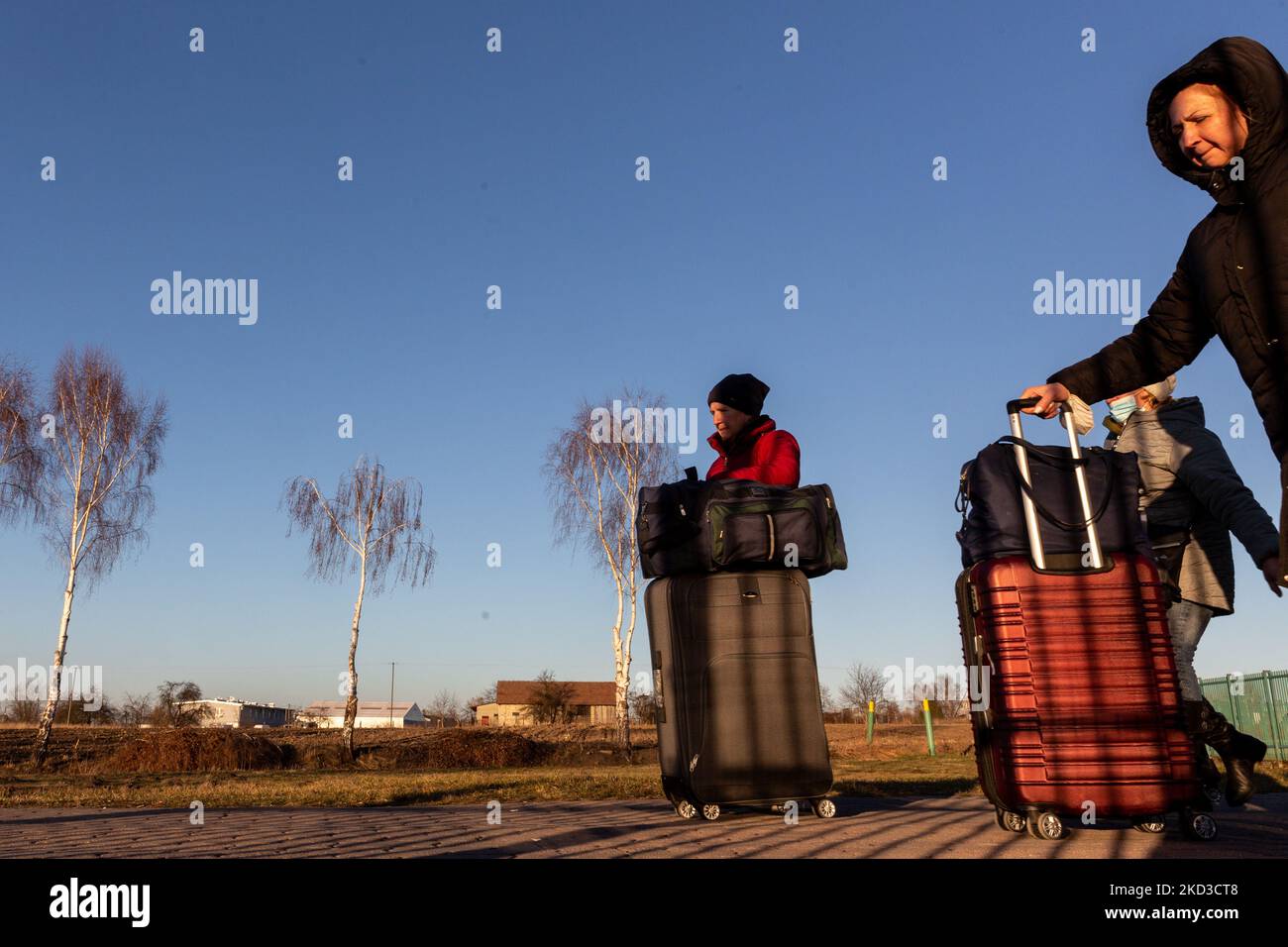 Ukrainian family walks through border passage as first migrants from ...