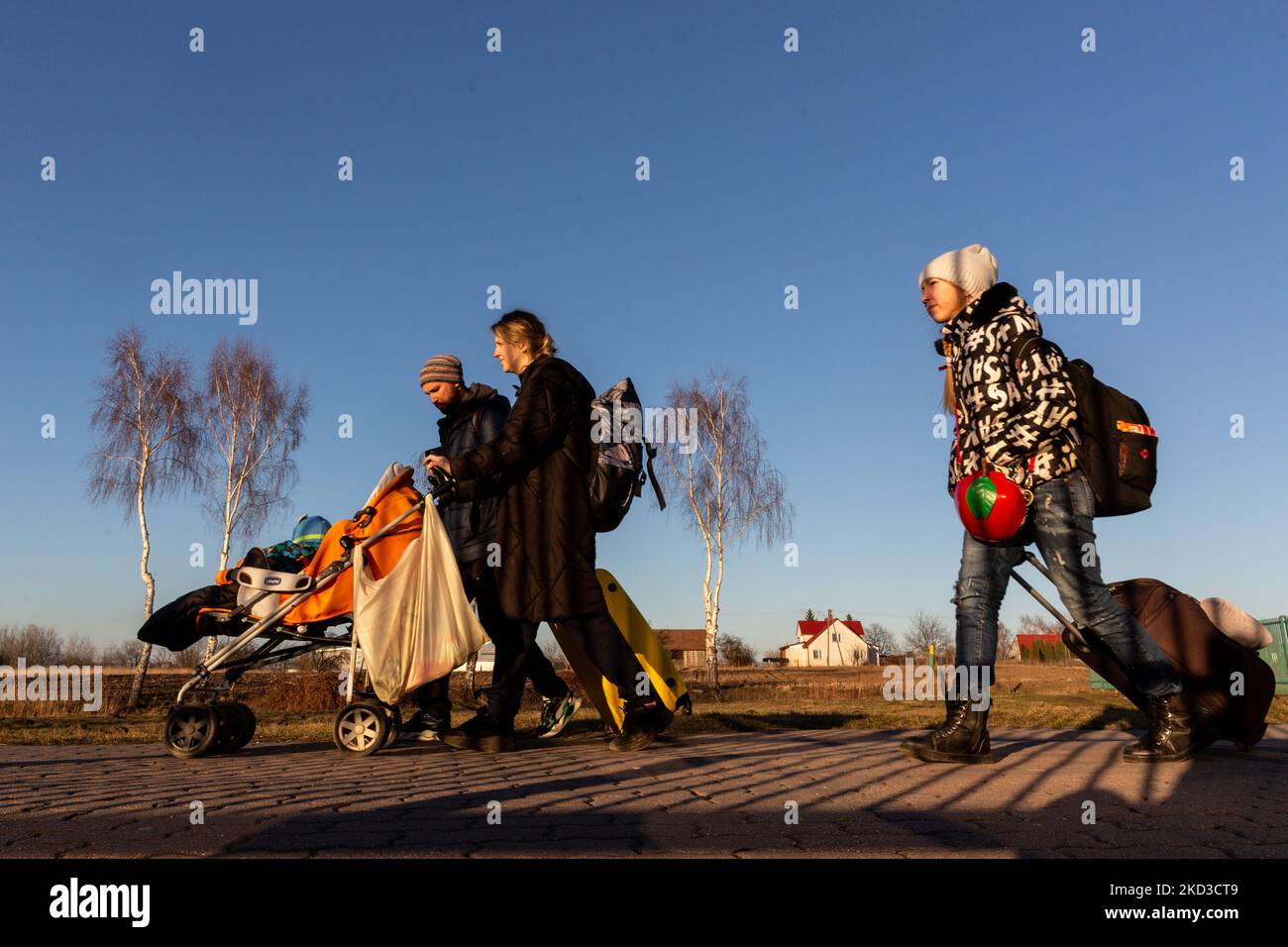 Ukrainian family walks through border passage as first migrants from ...