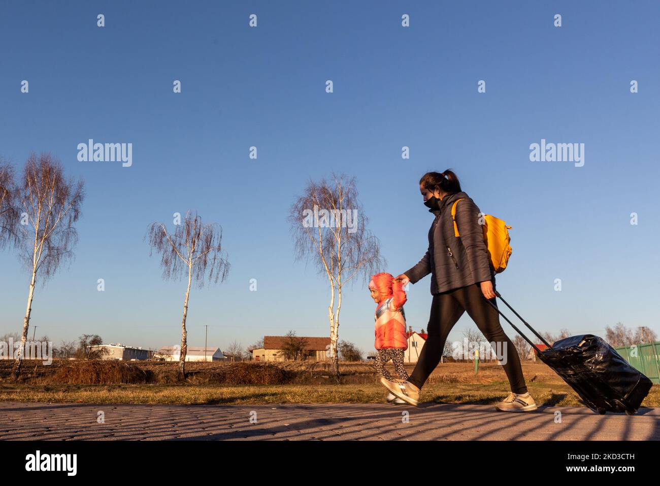 Ukrainian mother walks through border passage as first migrants from ...