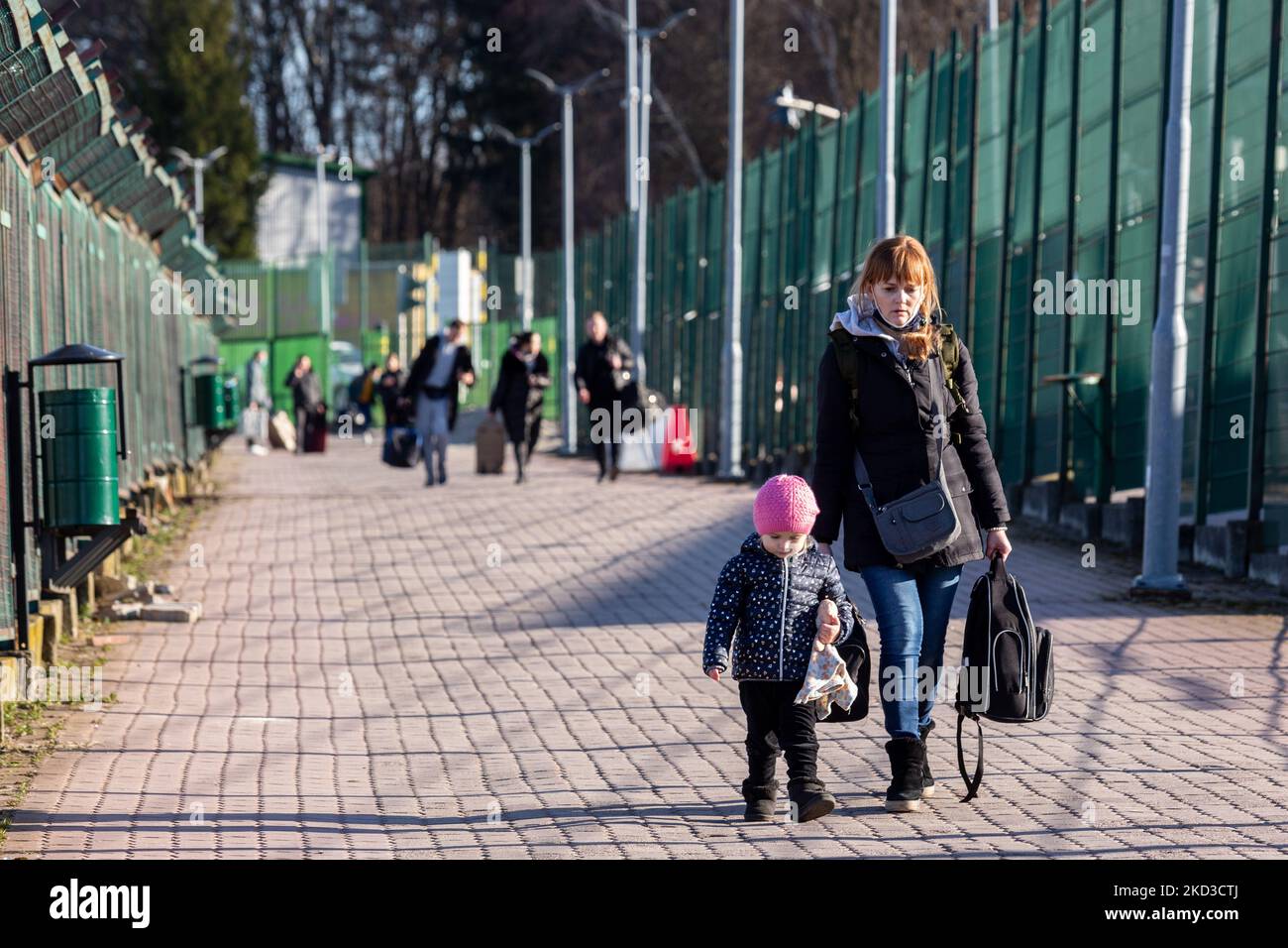 Ukrainian families walk through border passage as first migrants from ...