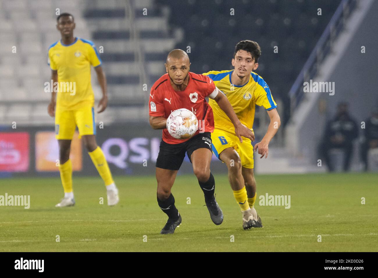 Yacine Brahimi (8) of Al Rayyan and Abdullah Ali Saei (6) of Al Gharafa ...
