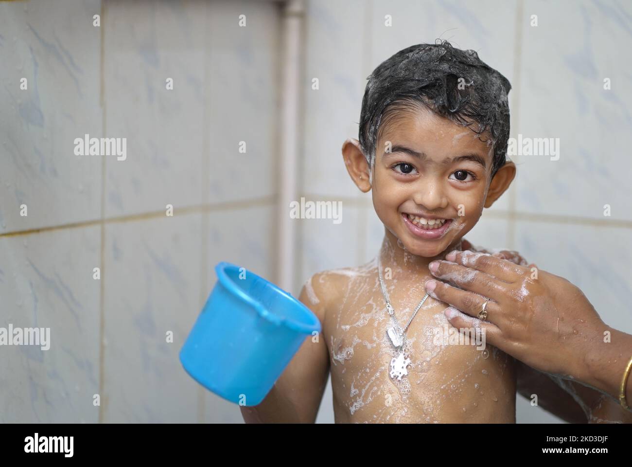 Indian mother washing baby hi-res stock photography and images - Alamy