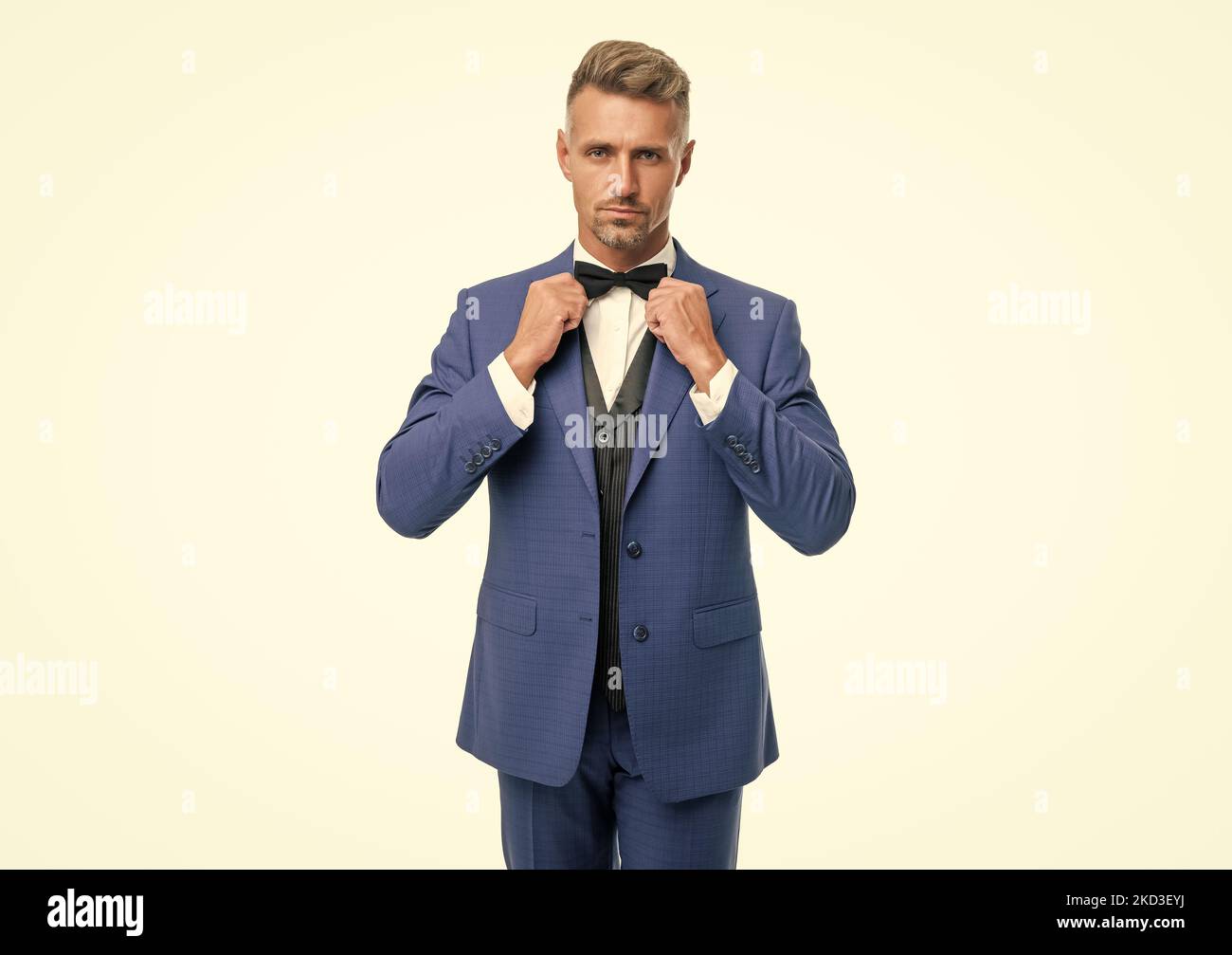 grizzled man in blue suit and bow tie. businessman isolated on white ...