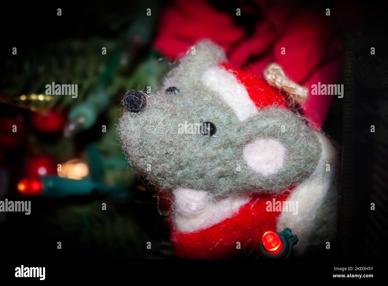 Felted Christmas mouse close-up on tree with artificial lights in ...