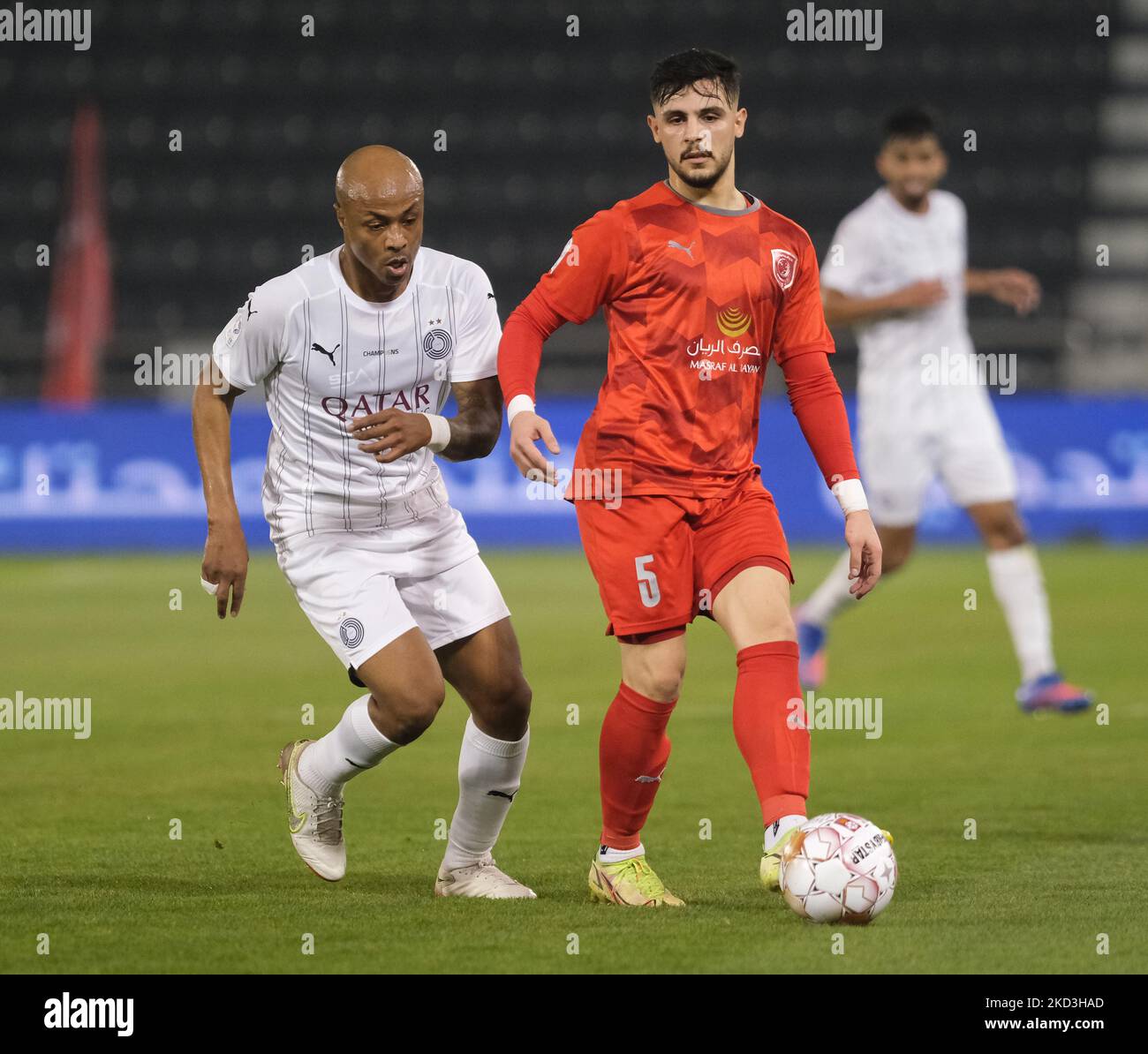 Bassam Al Rawi (5) passes the ball as Andre Ayew (24) of Al Sadd closes ...