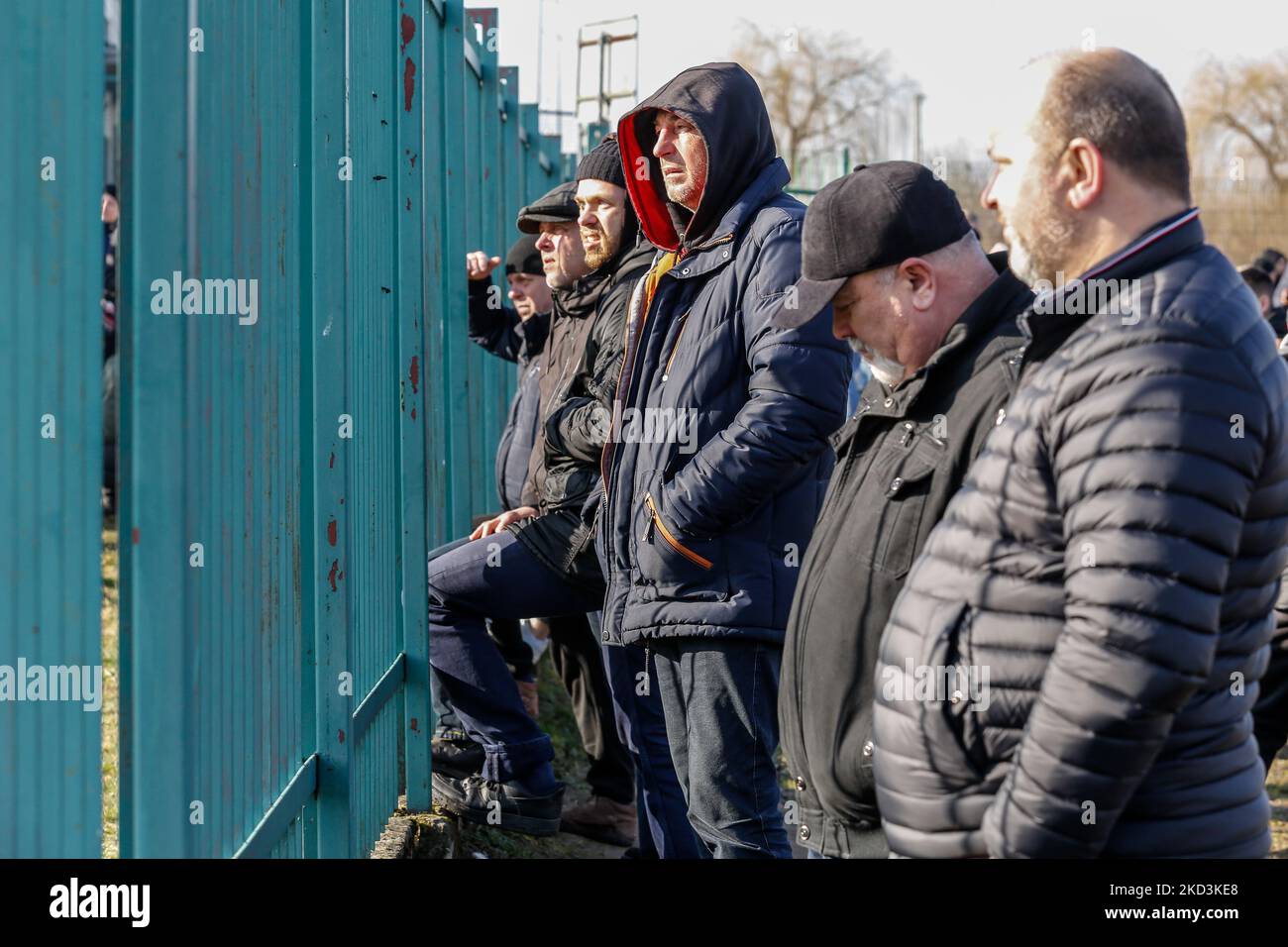 Ukrainian men wait by the border crossing passage for an arrival of ...