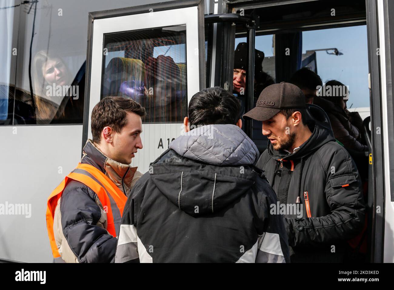 Ukrainians wait in a bus to be taken into inner Poland after arriving ...