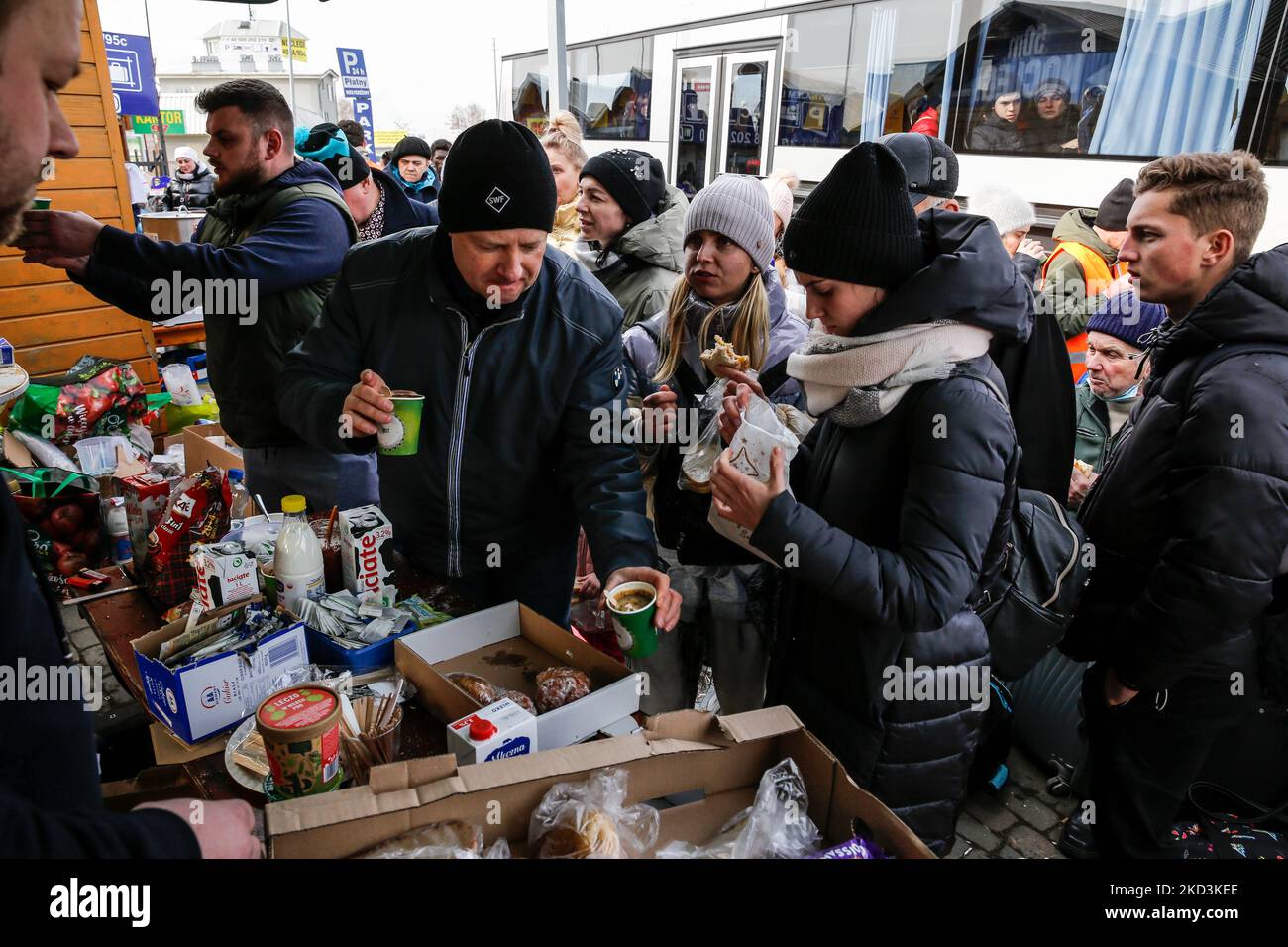 Ukrainians eat food provided by volunters after they arrived to Poland ...