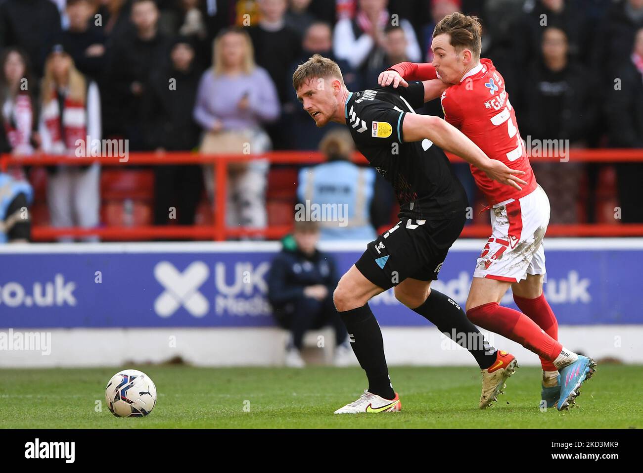 Robbie Cundy of Bristol City shields the ball from James Garner of ...