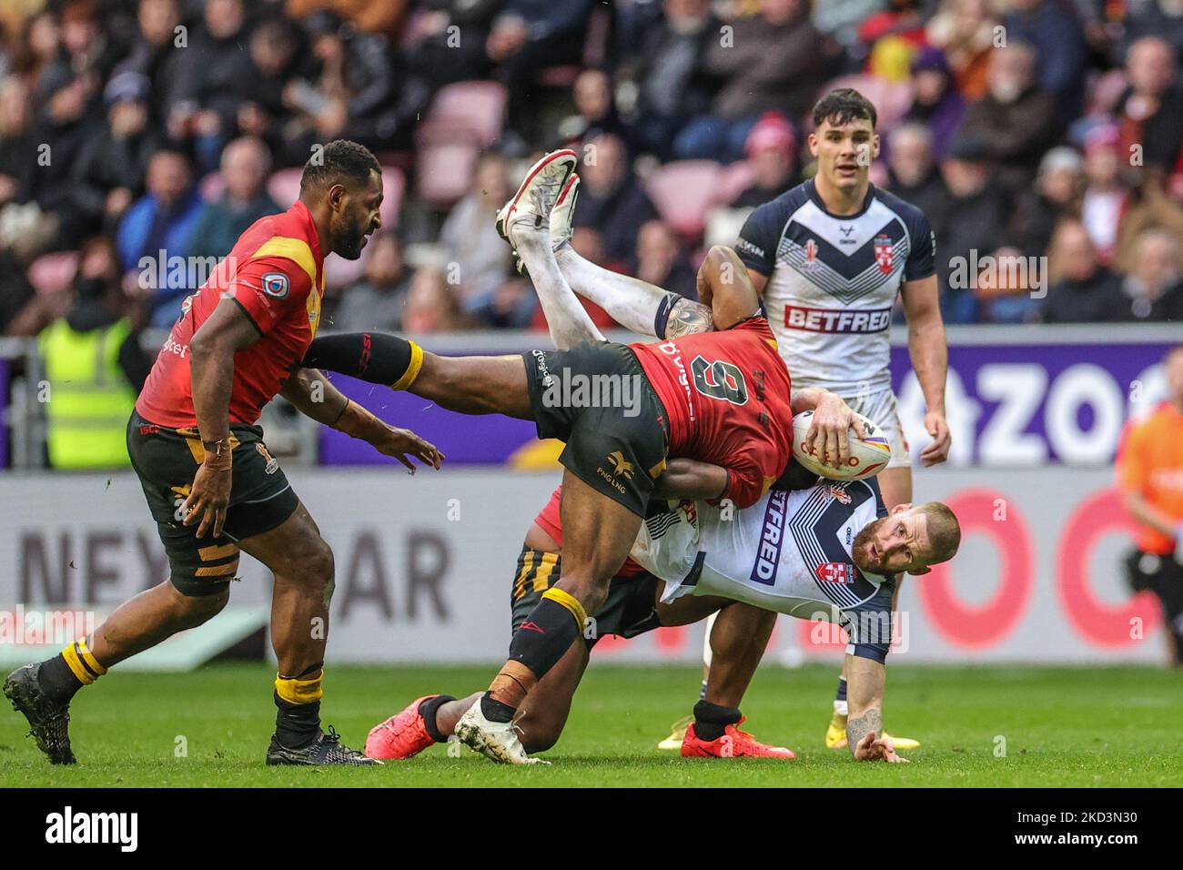 Sam Tomkins of England gets turned over by Edwin Ipape of Papua New ...