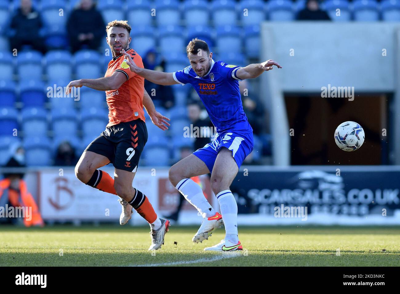 Oldham Athletic's Hallam Hope tussles with Tommy Smith of Colchester ...