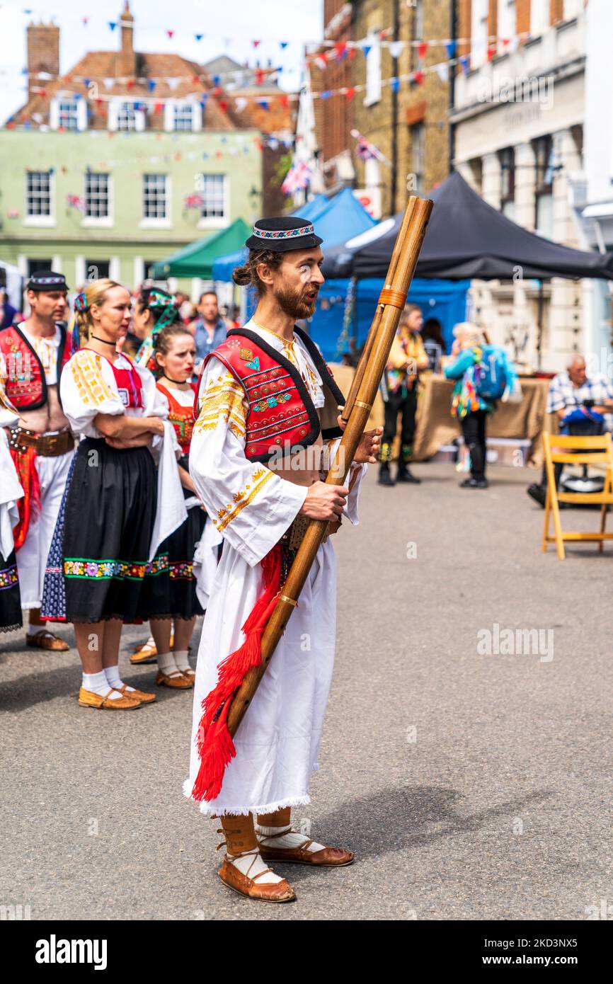 Bulgarian man, dressed in traditional national costume playing a wind ...