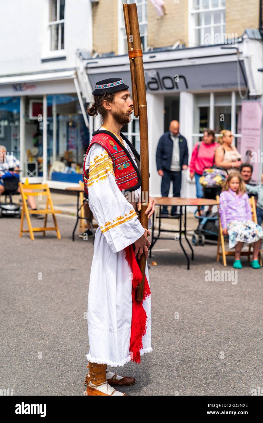 Bulgarian man, dressed in traditional national costume playing a wind ...
