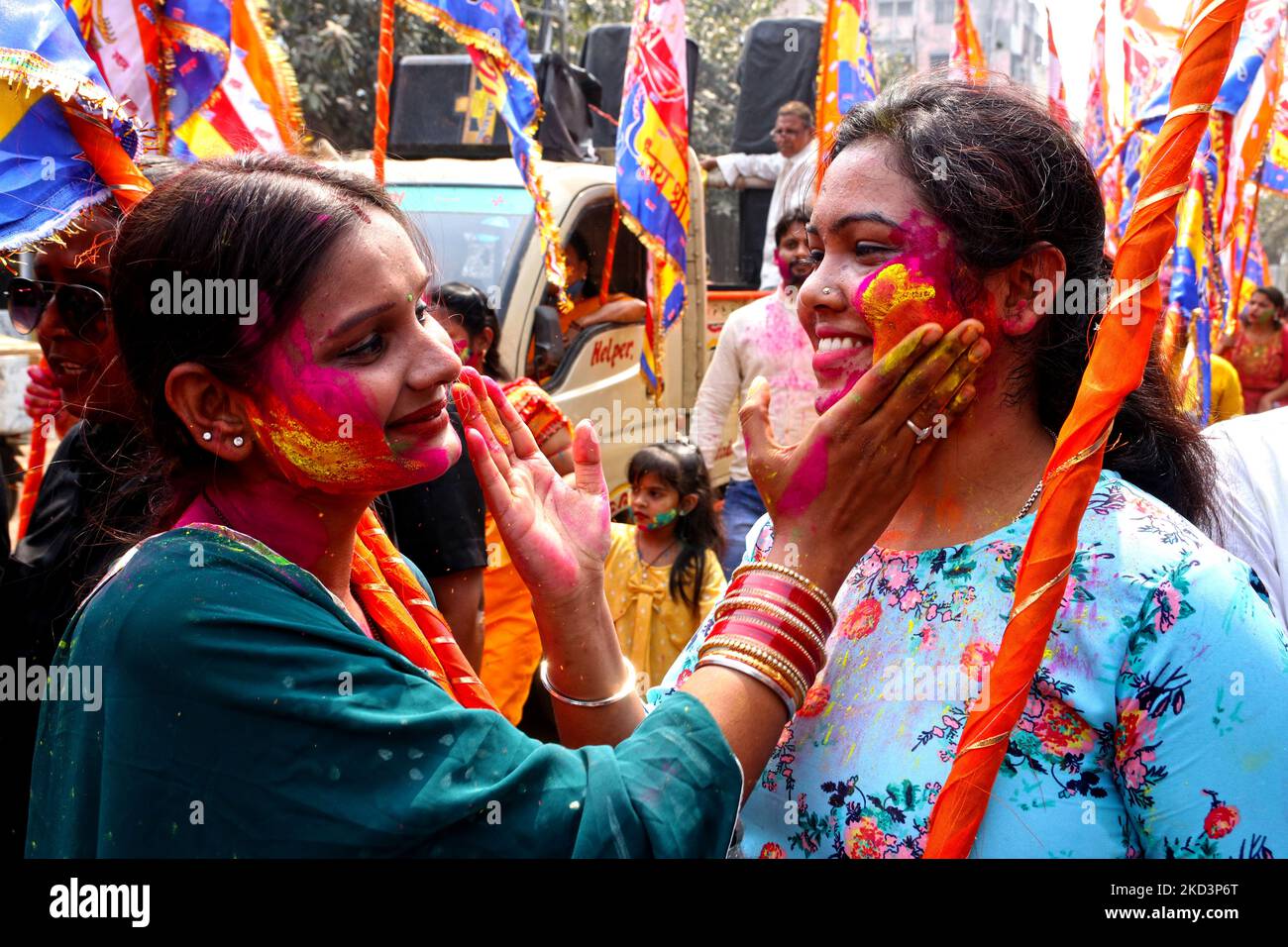 Hindu women apply coloured powder on themselves to celebrate the pre ...
