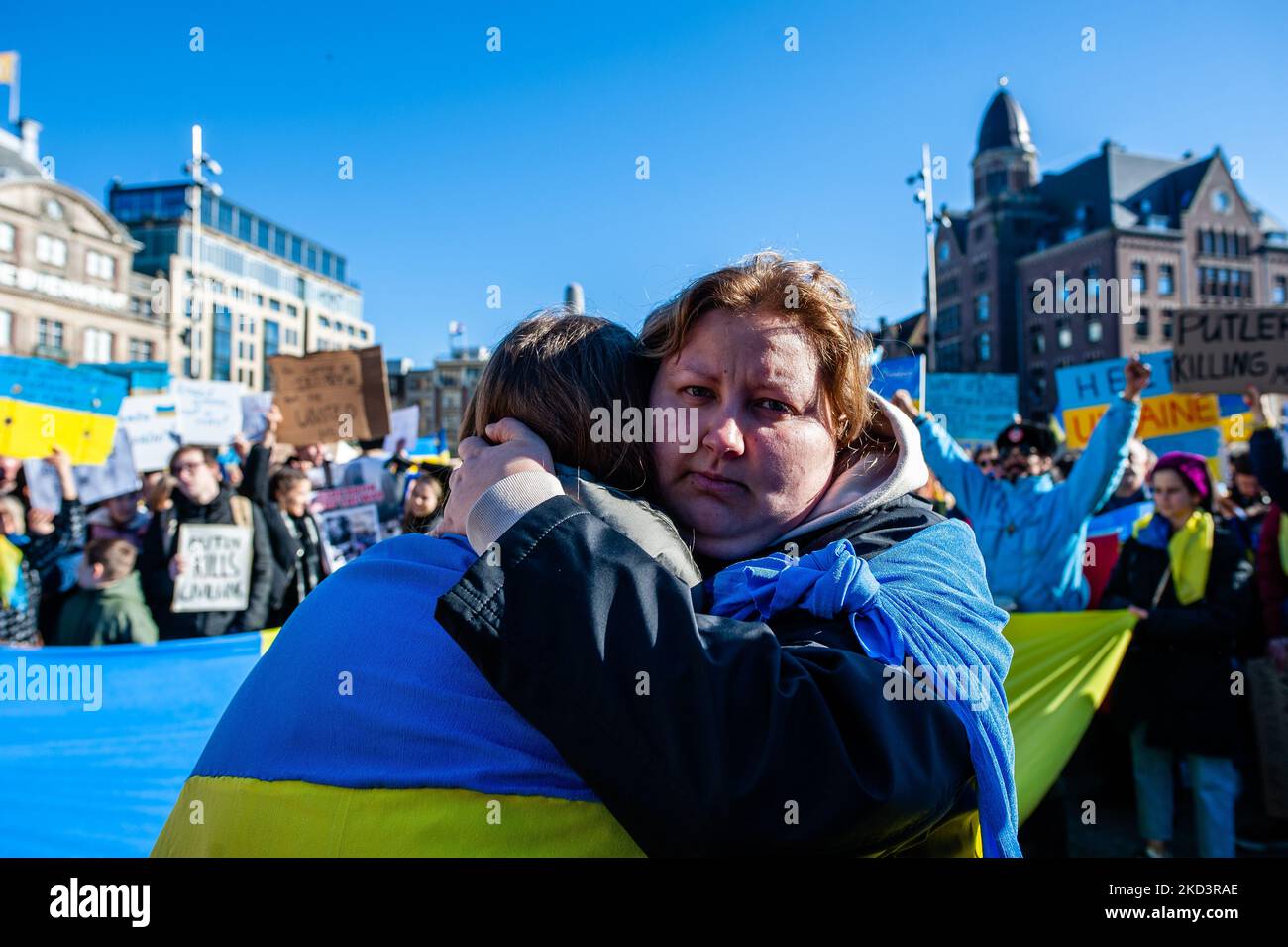 Two Ukrainian women are crying together, during the massive ...