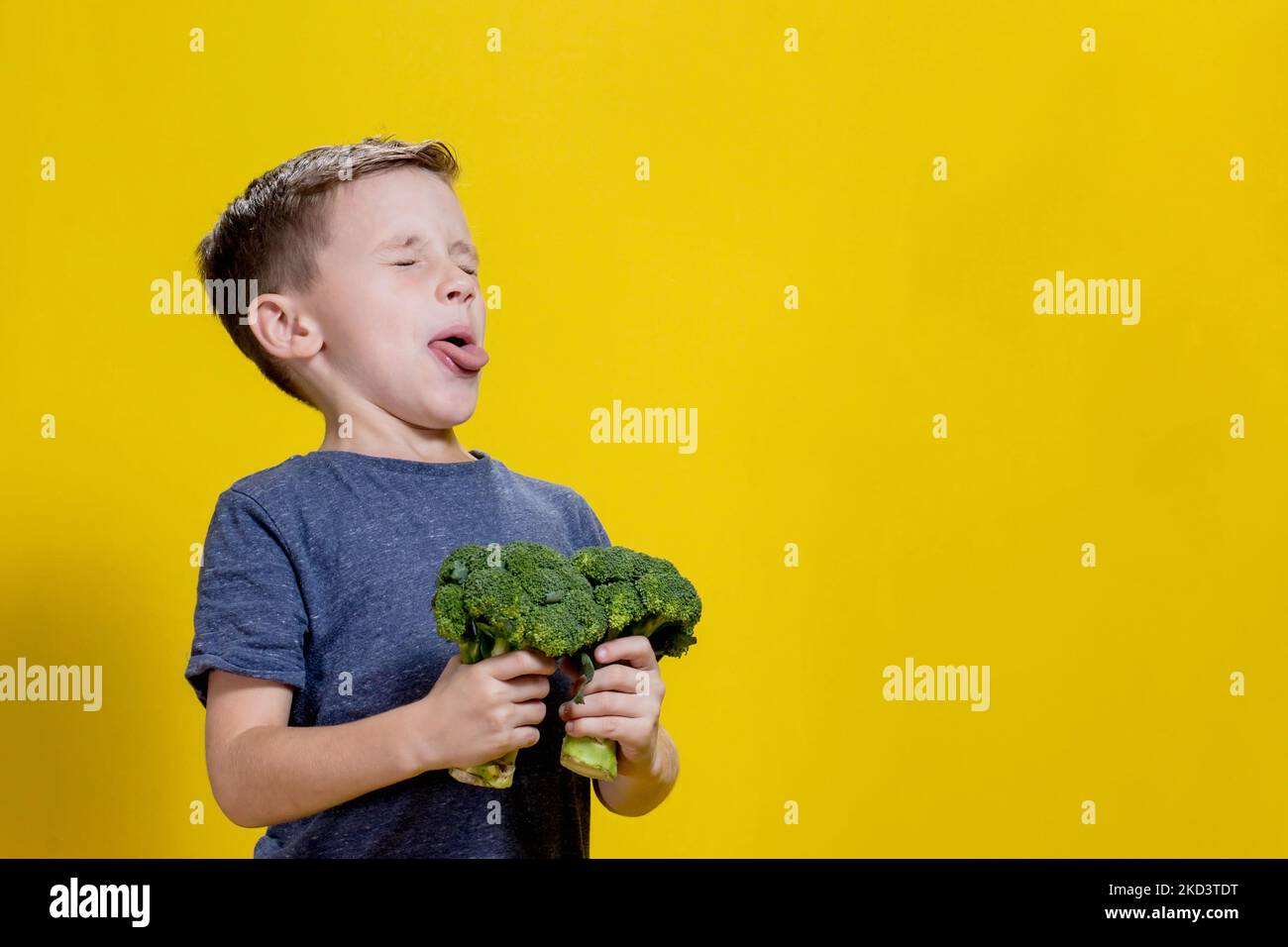 A charming little boy refusing to eat broccoli. Brootish broccoli Stock ...