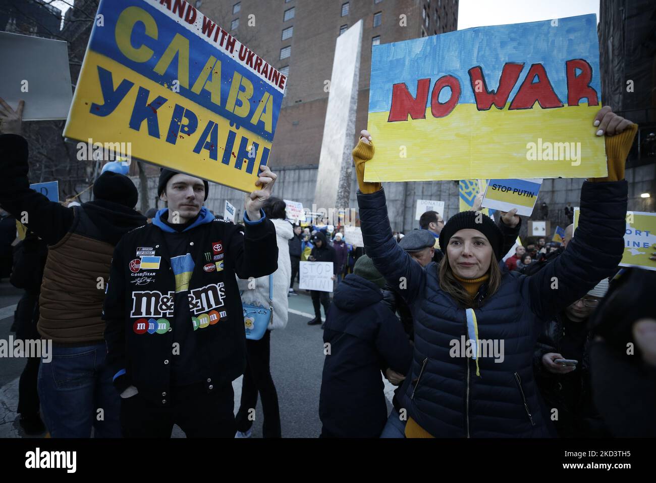 Ukraine supporters chant slogans with flags and signs during a rally in ...