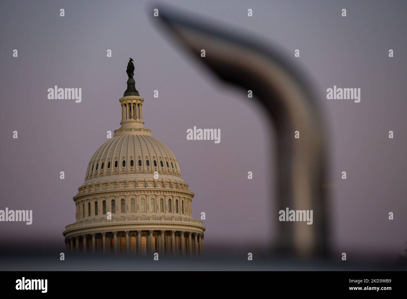 The dome of the U.S. Capitol building is seen beyond the exhaust pipe ...