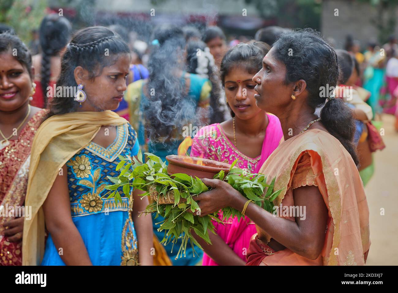 Tamil Hindu woman carries a clay pot with flaming camphor as she takes ...
