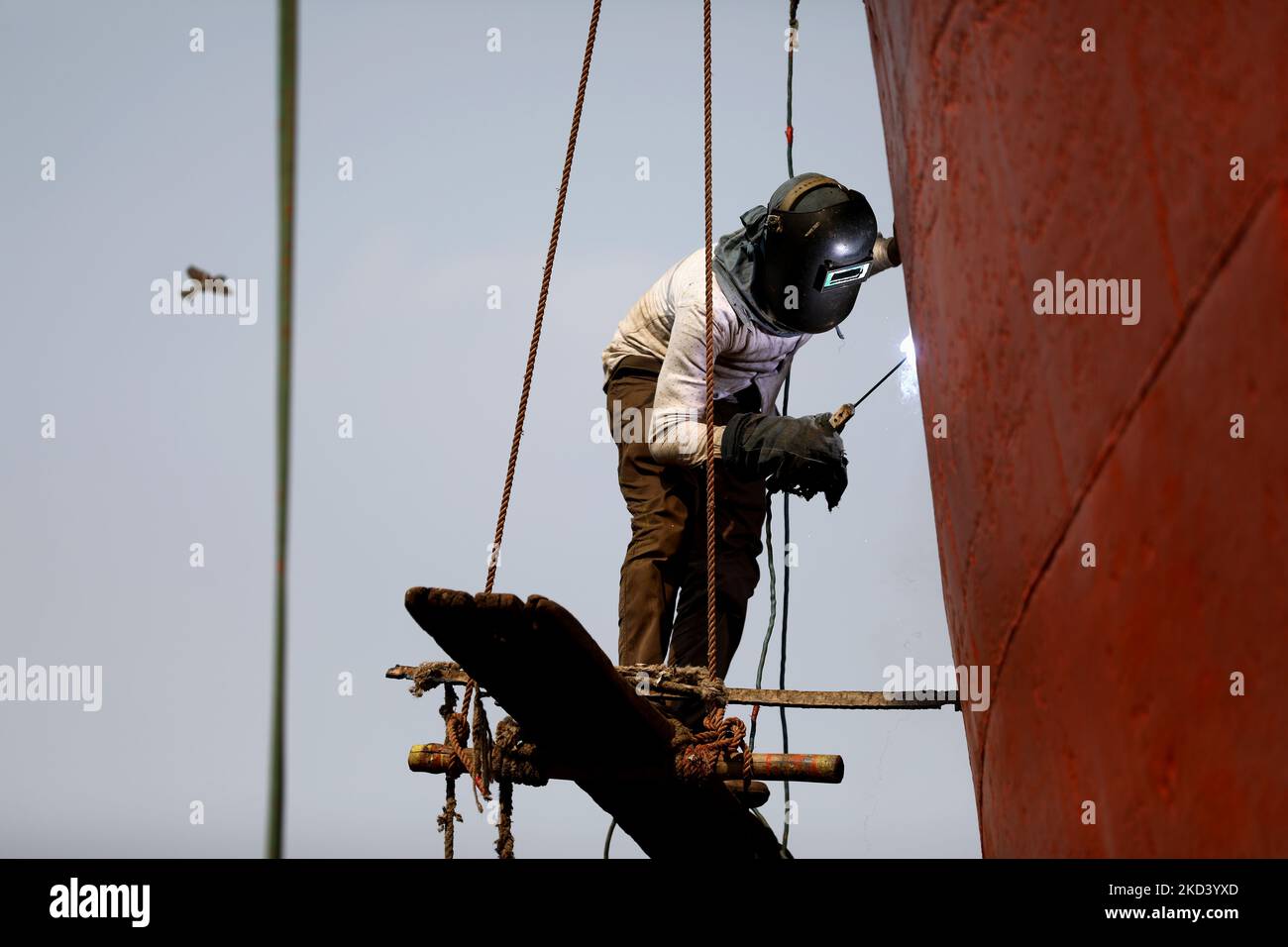A laborer works at a shipbuilding yard near the Buriganga River in ...