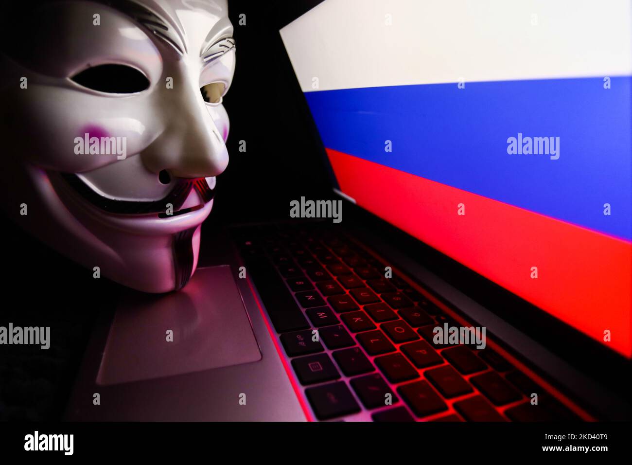 Russian flag displayed on a laptop screen and Guy Fawkes mask are seen ...