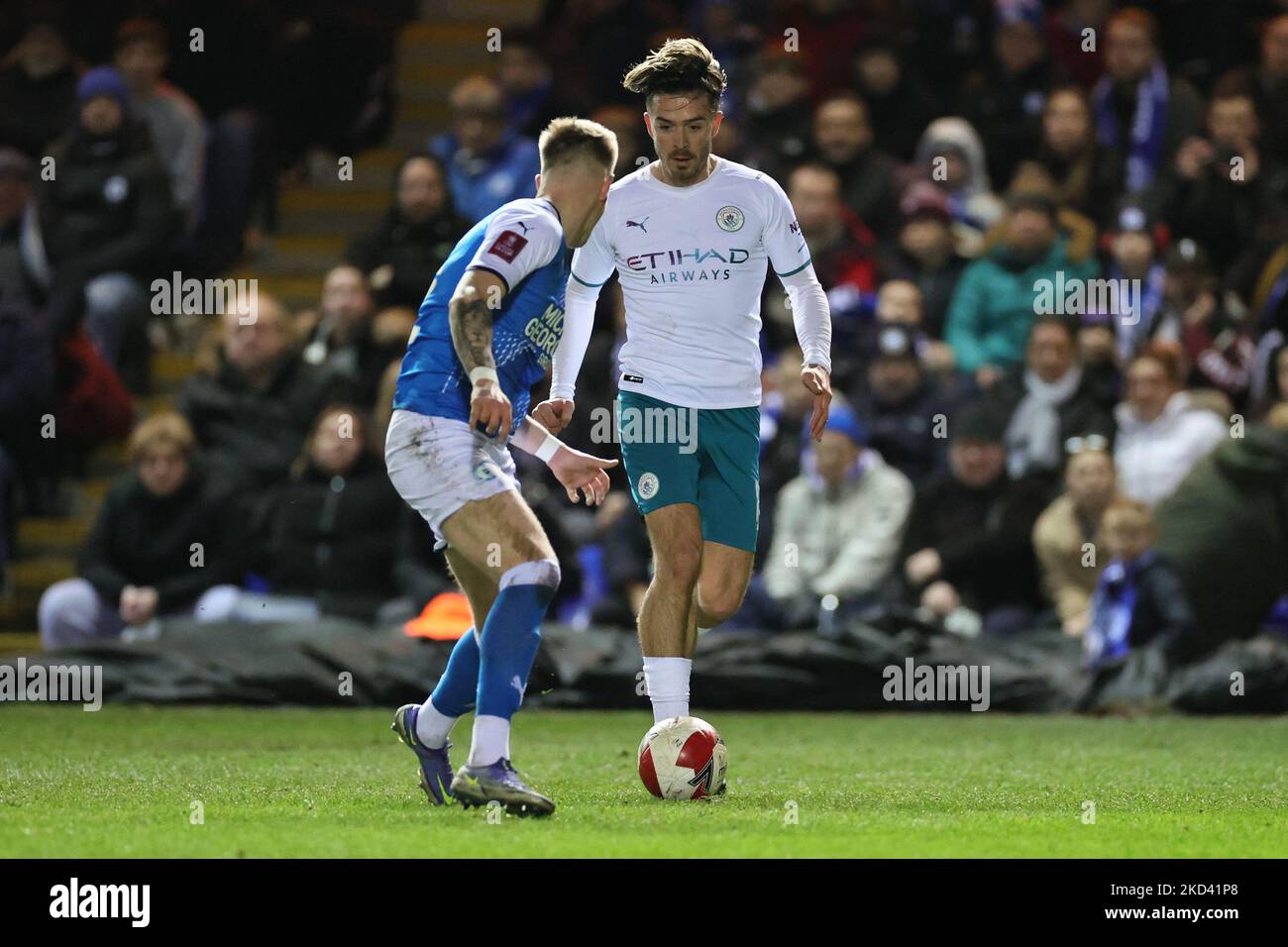 Jack Grealish of Manchester City runs with the ball under pressure from ...