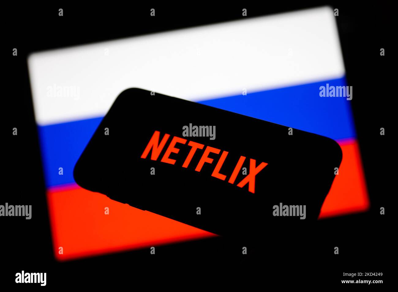 Netflix logo displayed on a phone screen and Russian flag displayed on ...