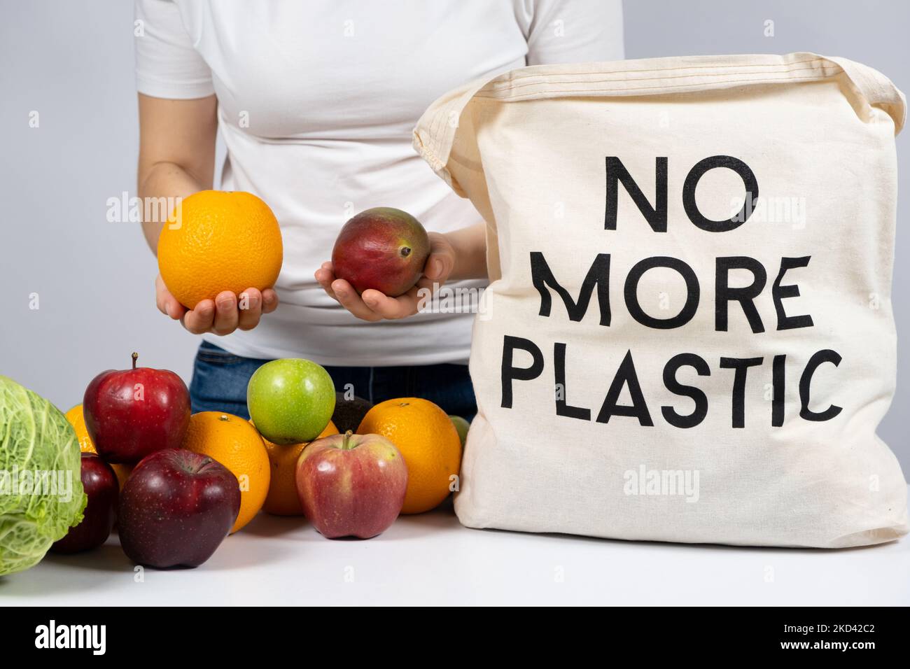 A woman puts products in a fabric eco bag with no more plastic. The ...