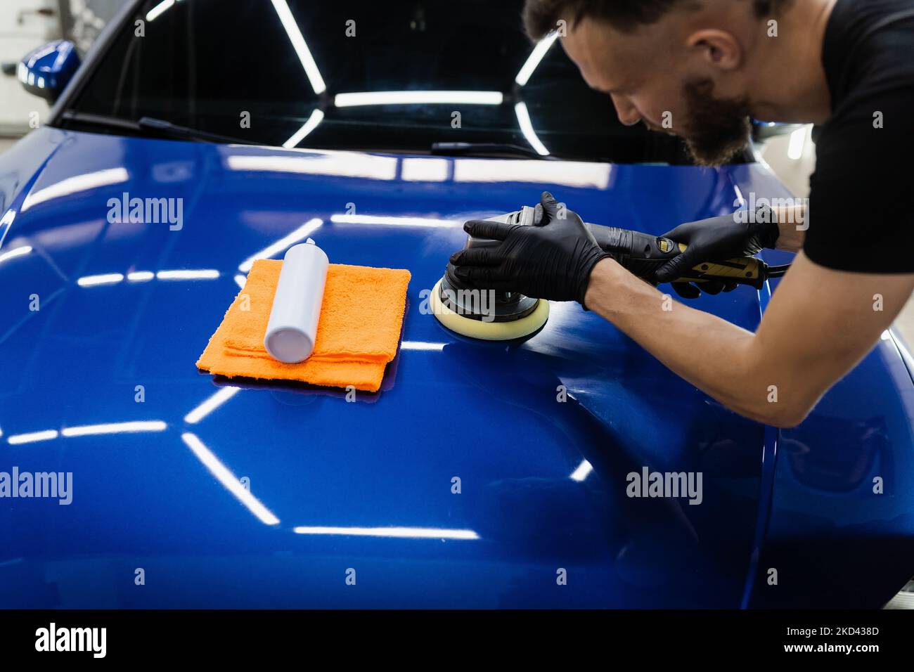 Car polishing with orbital polisher for remove scratches. Worker of ...