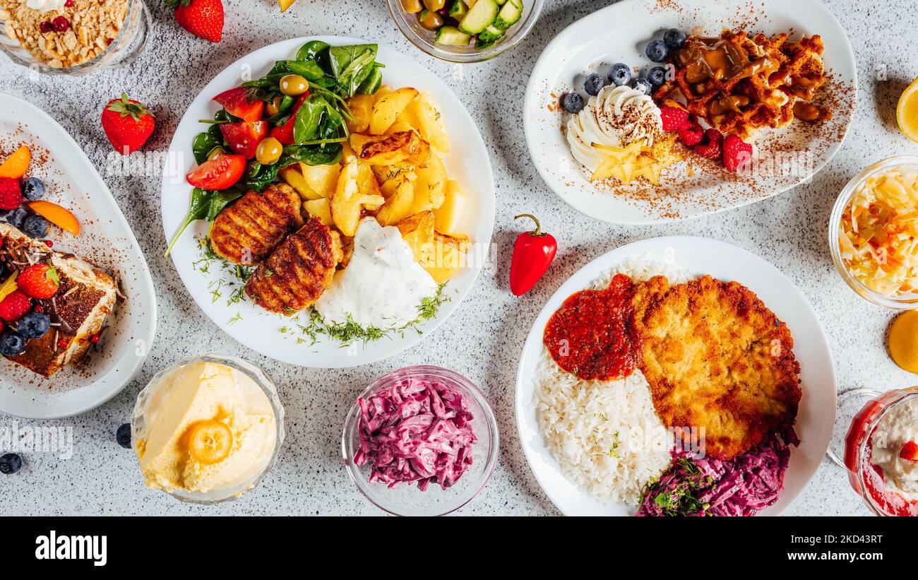 A top view of a table full of colorful meals including different ...