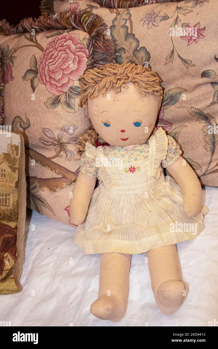 Old stained rag doll with painted eyes and mouth and embroidered ...