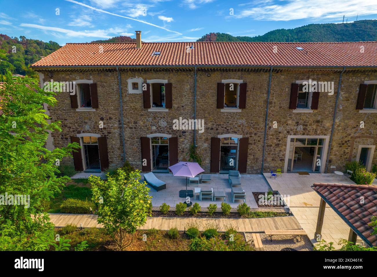 An aerial view of a facade of a big stone house with lot of windows ...
