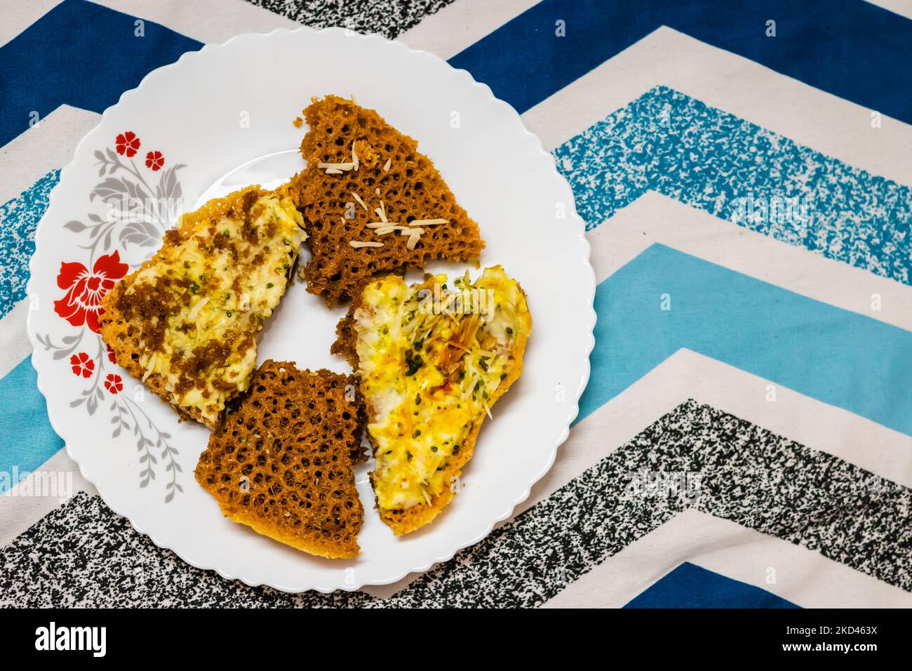 indian traditional sweet ghevar served in white plate from different ...