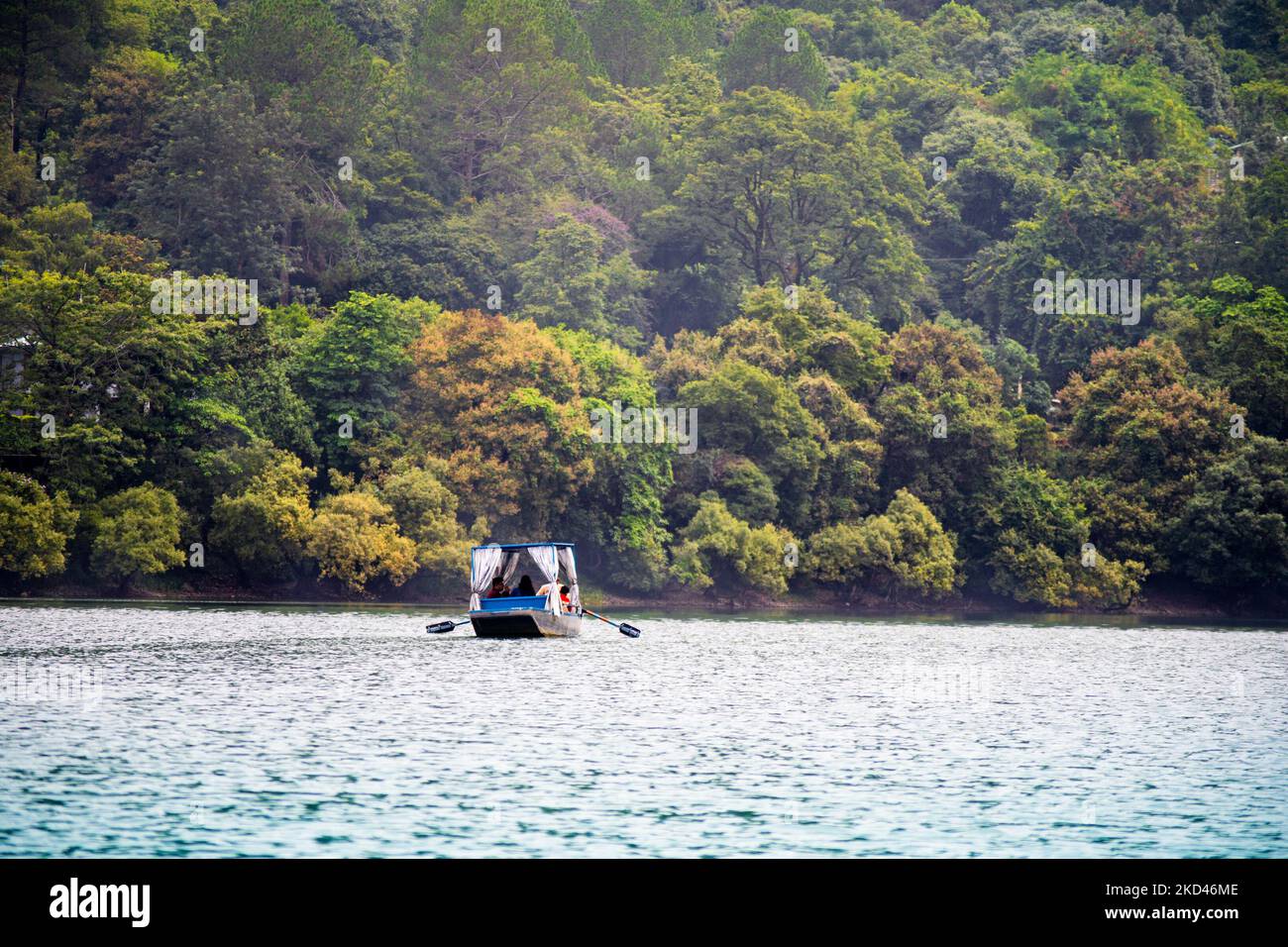 panning shot showing family in house boat in kashmir bhimtal ...