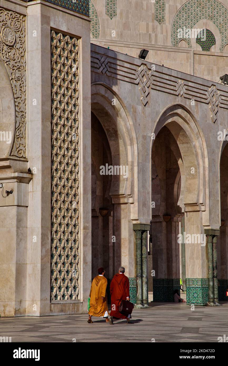 Muslims walk along the courtyard of the Hassan II Mosque before prayers ...