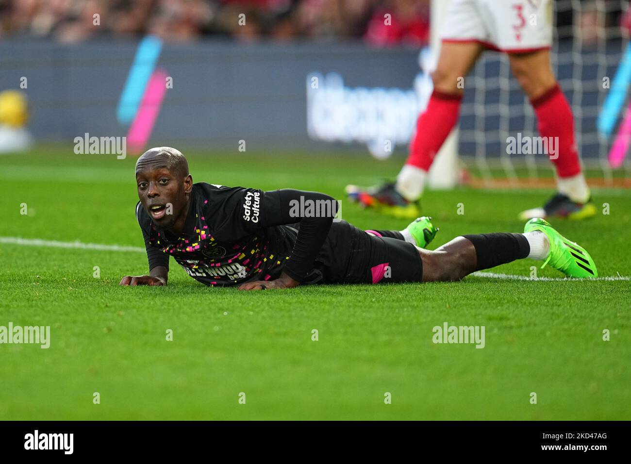 Yoane Wissa of Brentford looks stunned whilst on the floor after being ...