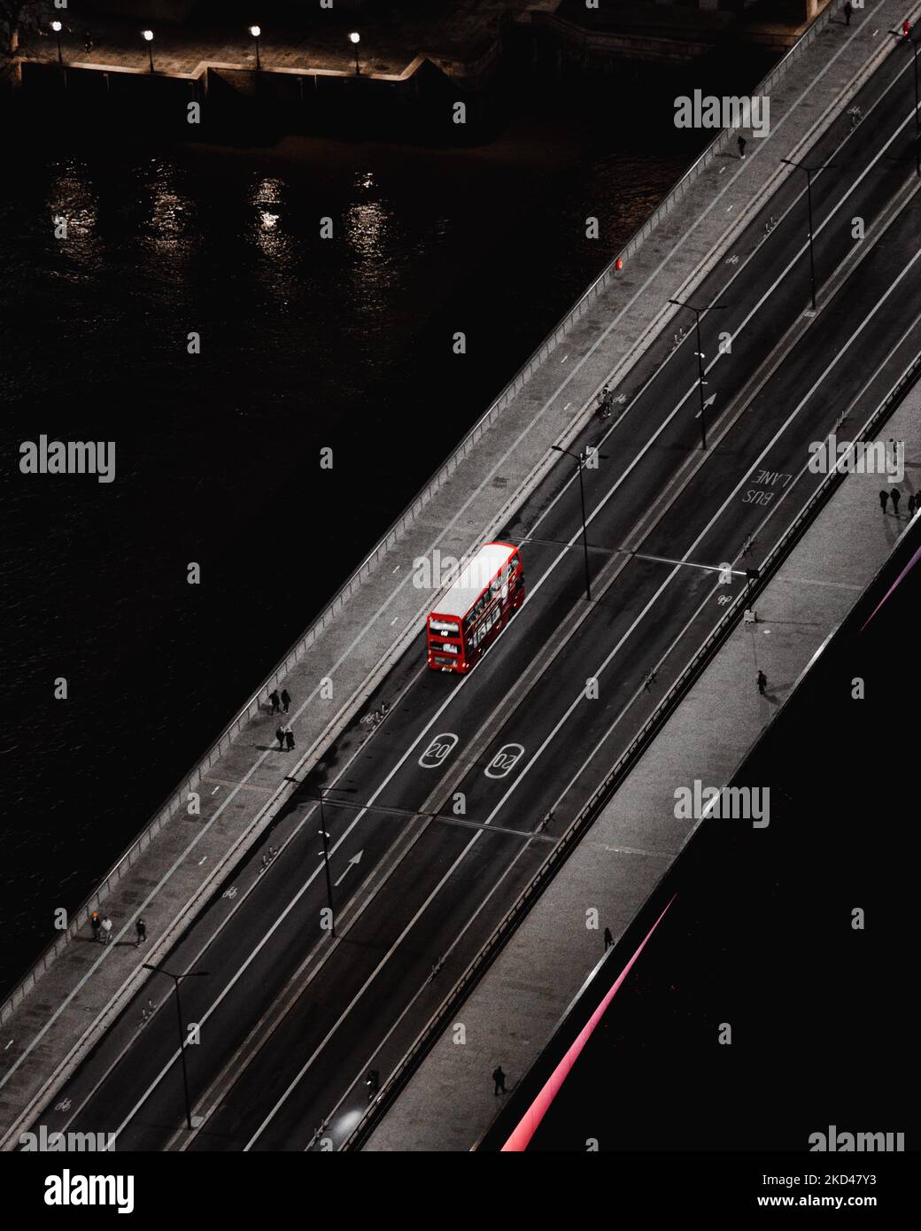 An aerial view of the iconic London red bus driving on the bridge at ...