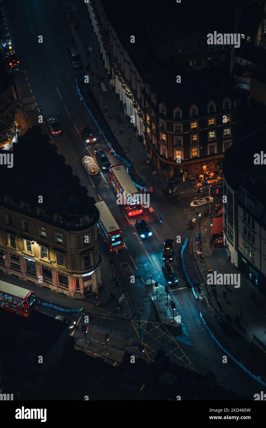 An aerial view of cars and buses riding on the street at night in ...