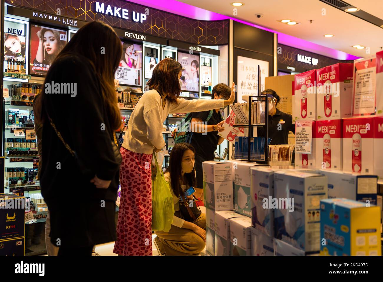 Hong Kong, China, 5 Mar 2022, Women look at rapid tests and respirator ...