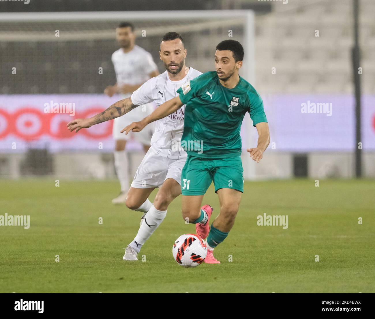 Khaled Mohammed (31) of Al Ahli on the ball as Guilherme Torres (17) of ...