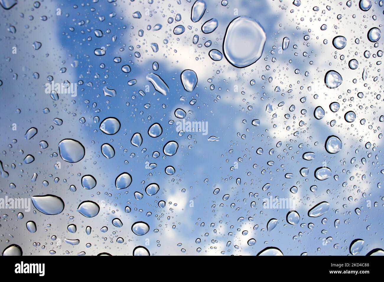 Sky and Clouds through large raindrops on window background Stock Photo ...