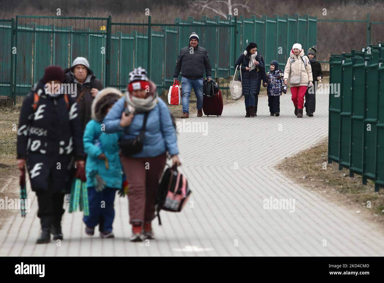 People fleeing from Ukraine walk after crossing the border in Medyka ...
