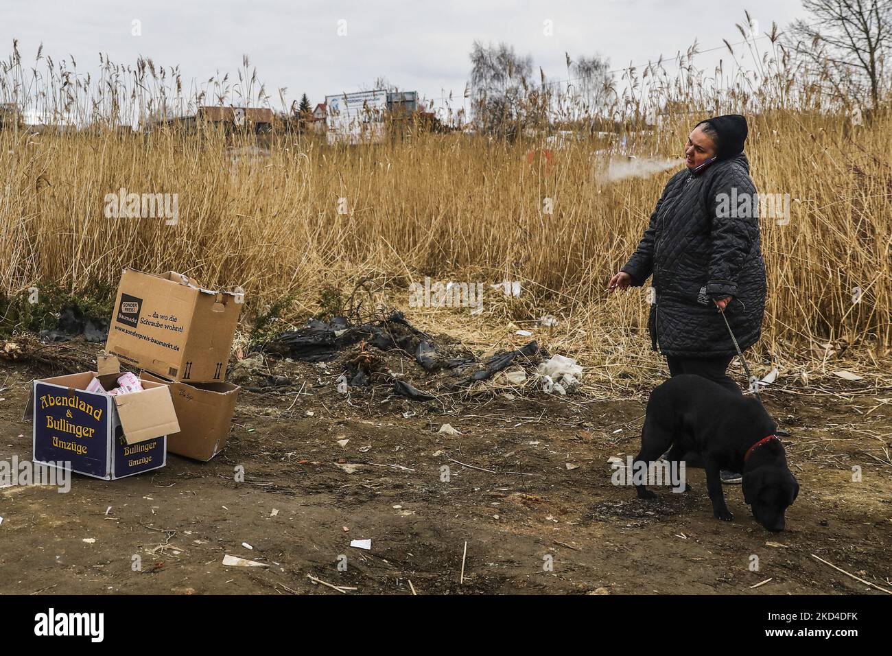 A refugee woman with a dog fleeing from Ukraine is seen after crossing ...
