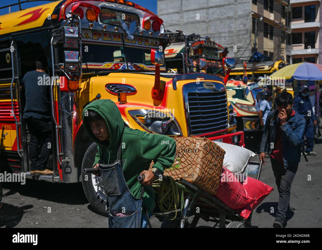 Chicken buses at the bus terminal in the city of Huehuetenango. On ...
