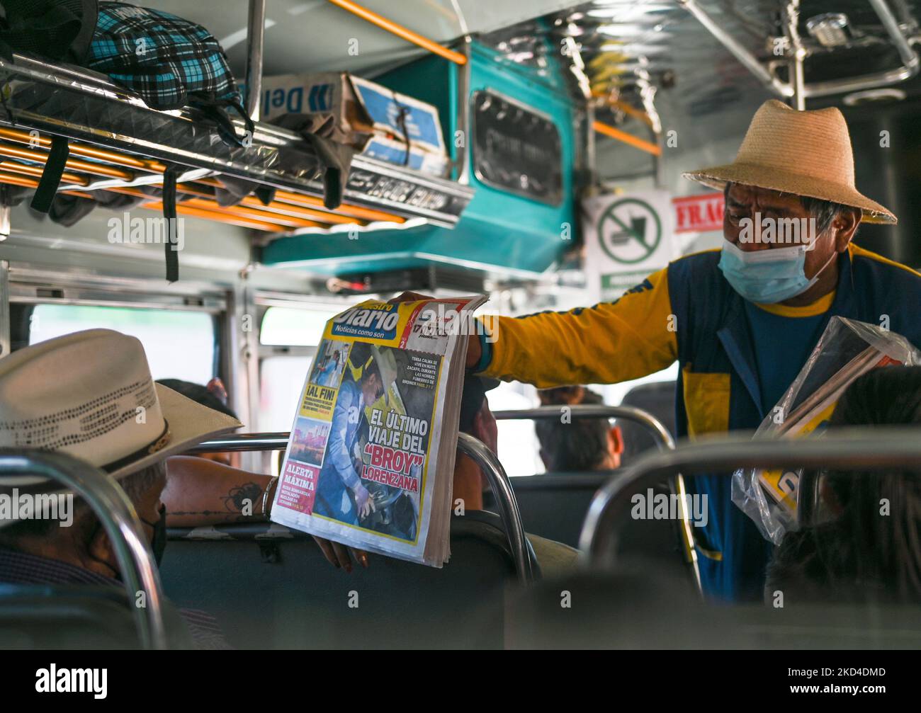 A newspaper vendor on the Chicken bus at the bus station in the city of ...
